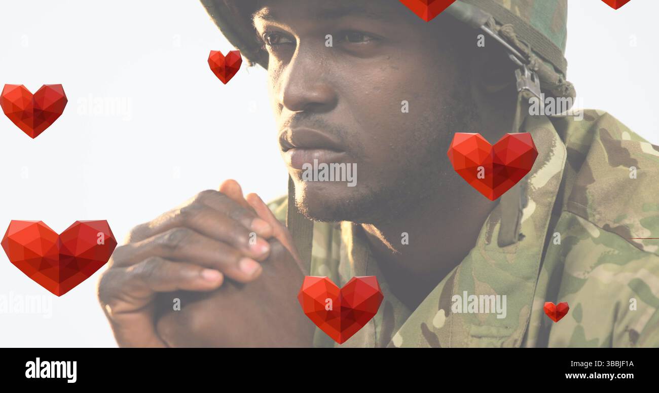 Image of hearts falling over african american male soldier praying ...