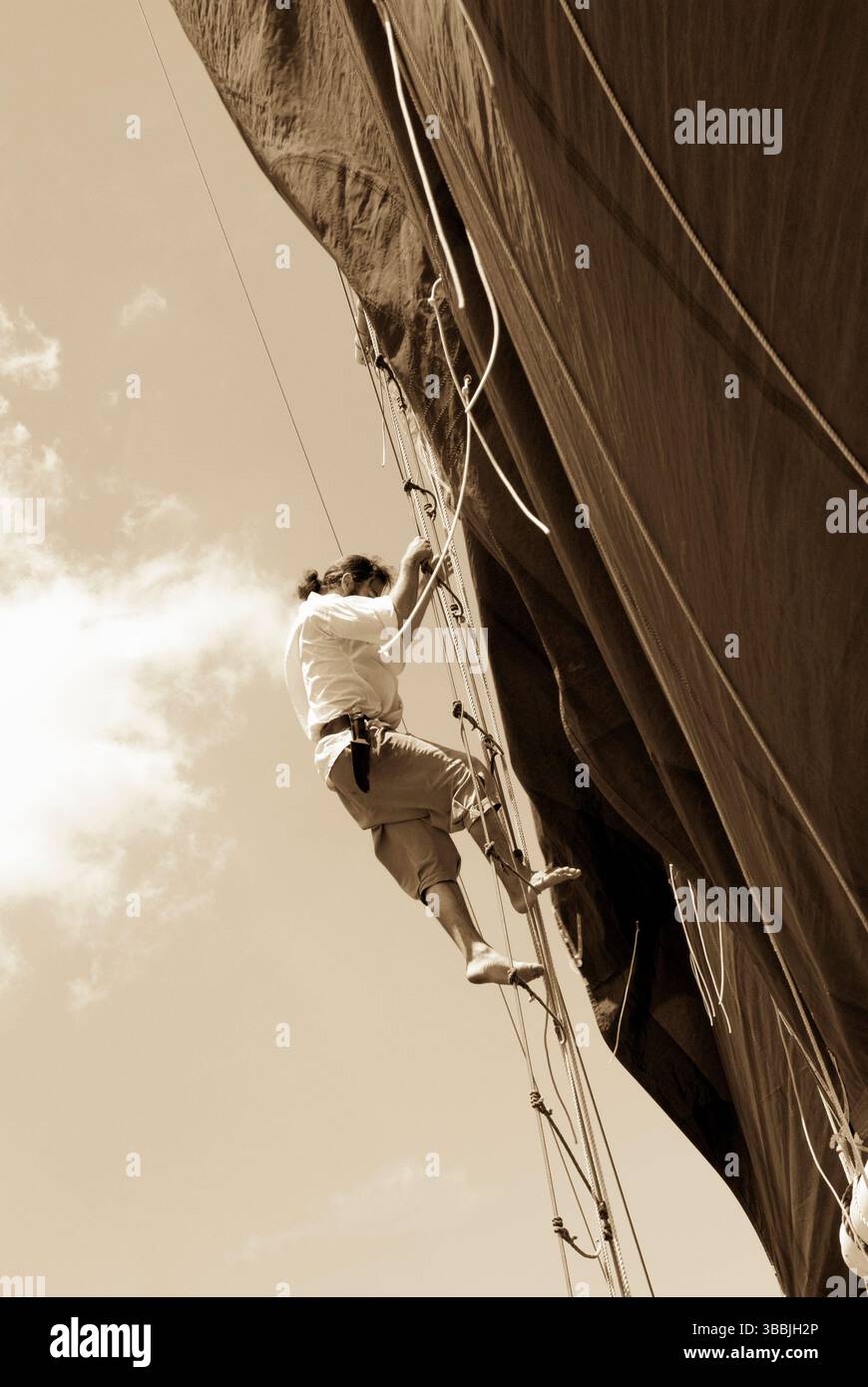 Pirate climbing rope ladder aboard the Jolly Rover tall ship docked on ...