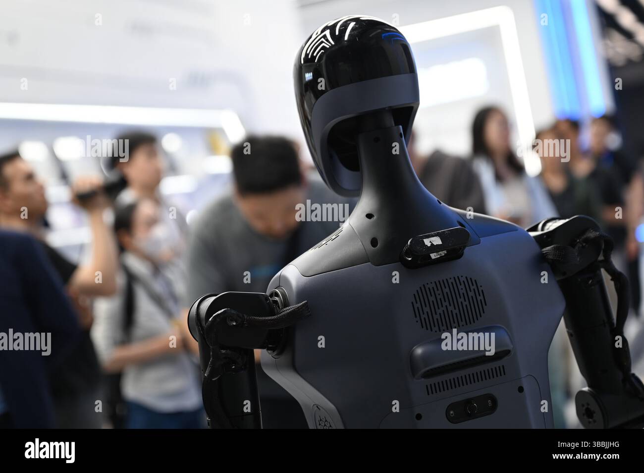 16 May 2025, China, Peking: People take photos of the humanoid robot ...