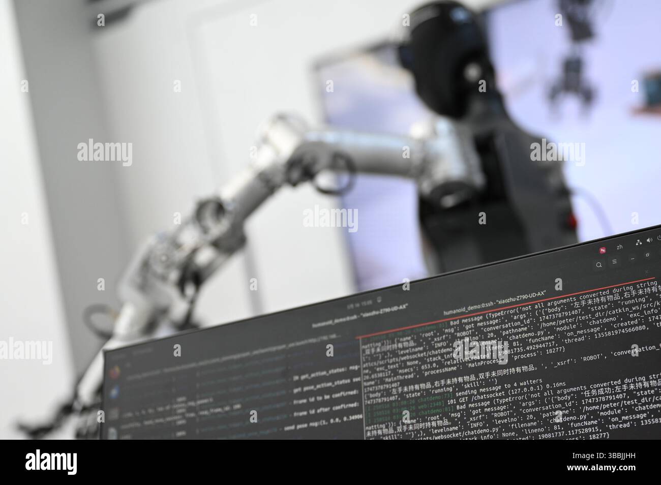 Peking, China. 16th May, 2025. A robot of the "Tiangong" model stands in front of a screen on ...