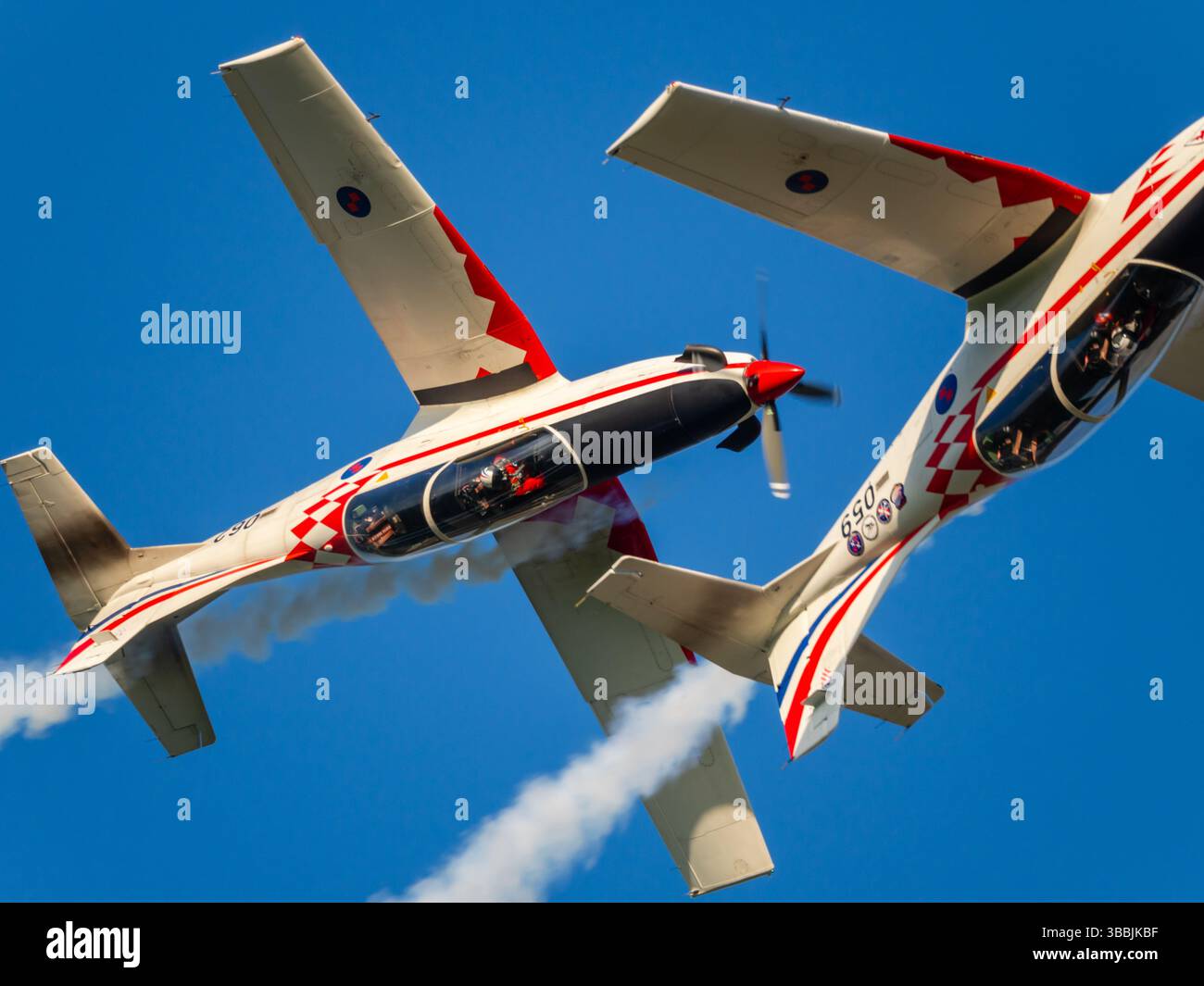 Flying aircraft against clear Blue sky violent inverted very extreme ...