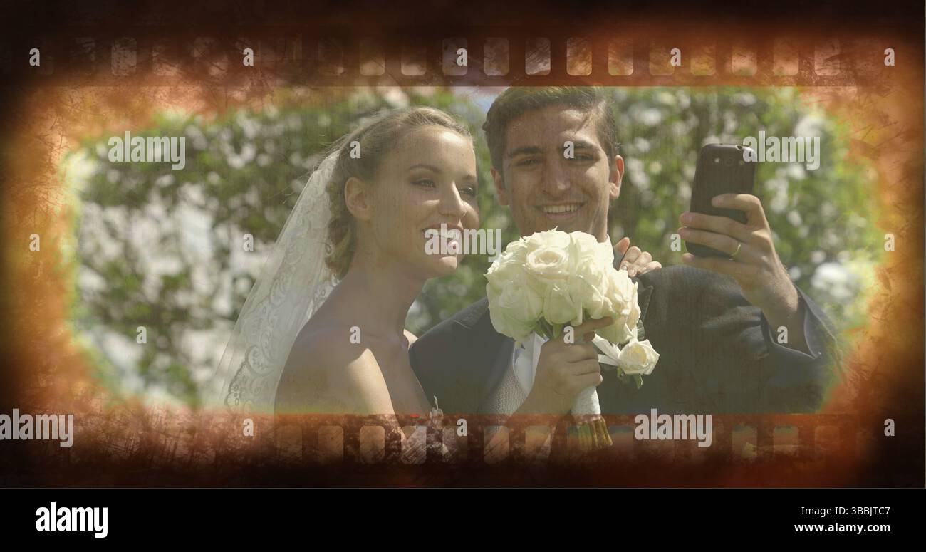 Taking selfie bride and groom wearing wedding attire in garden, with ...