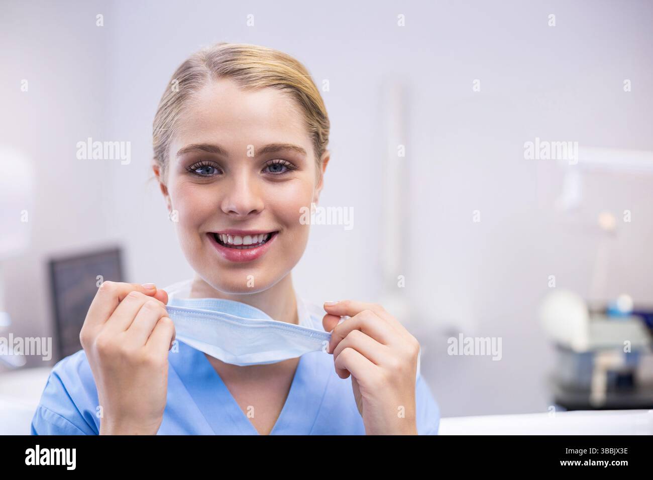 Light blue disposable surgical mask resting on bright medical ...