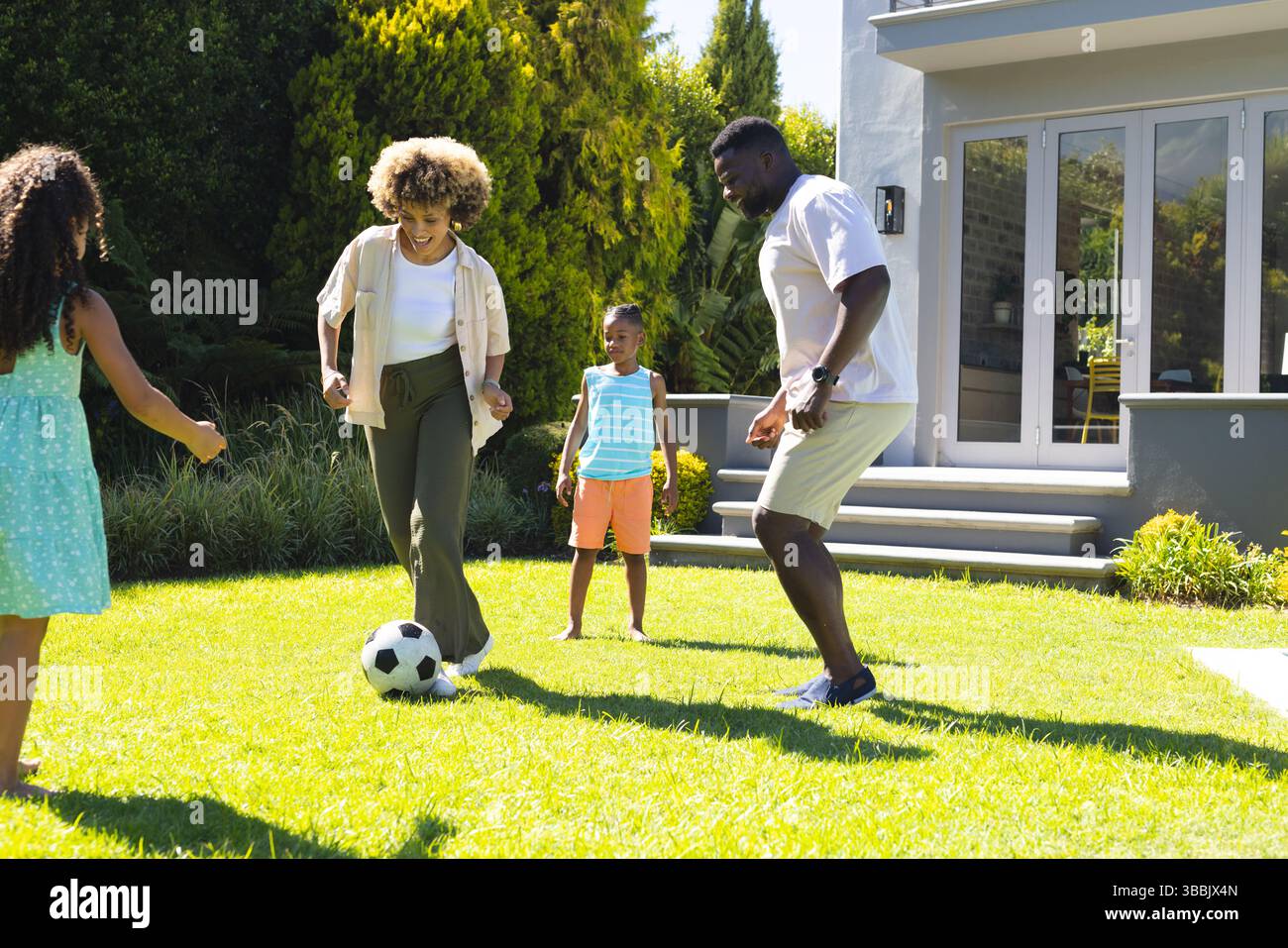 Playing diverse family kicking hi-res stock photography and images - Alamy