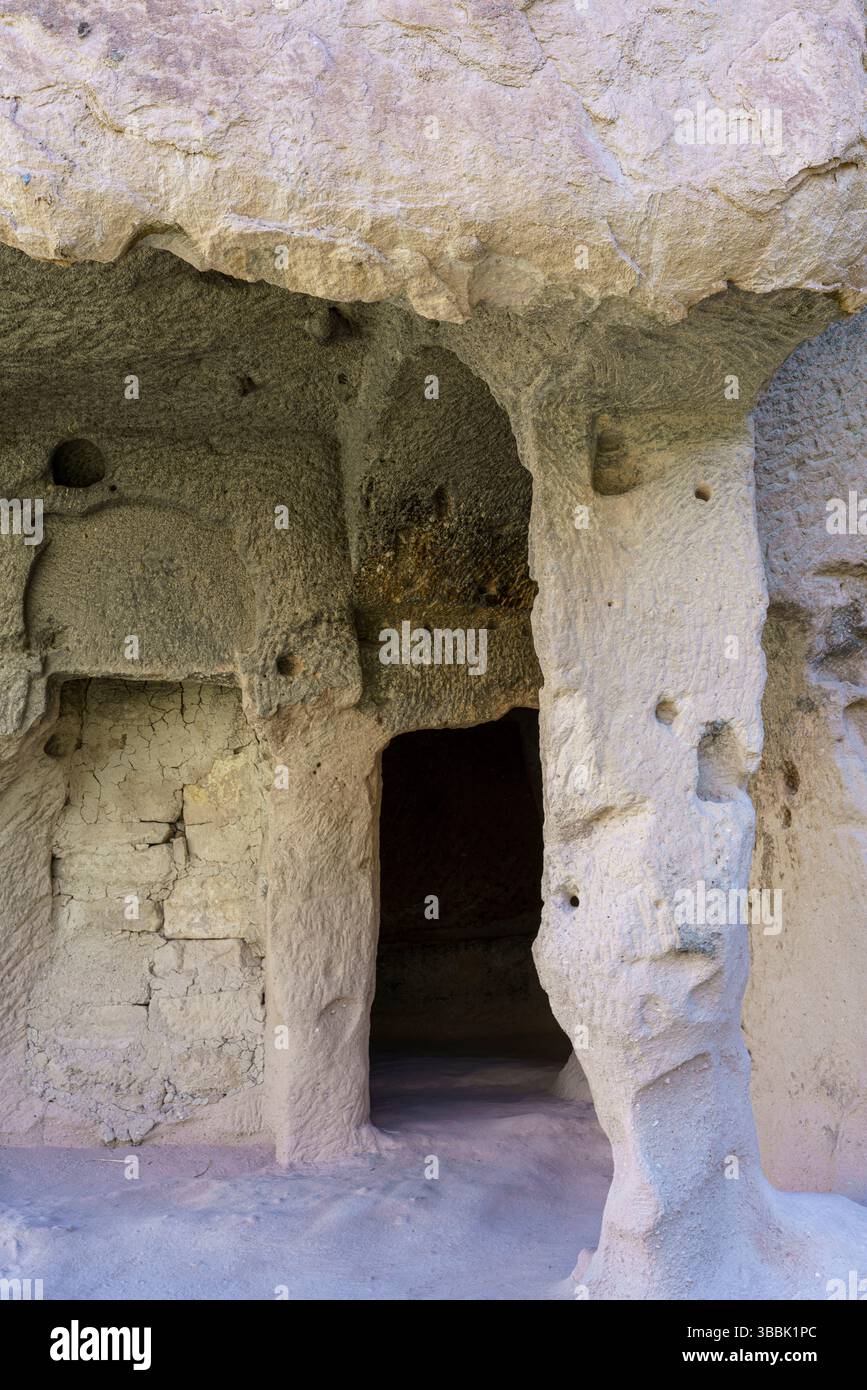 A simple rectangular cave entrance carved in soft stone is part of ...