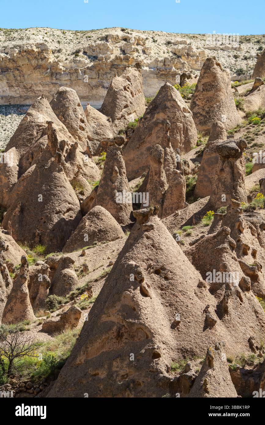 Pointed fairy chimneys and eroded rock formations cluster together in ...