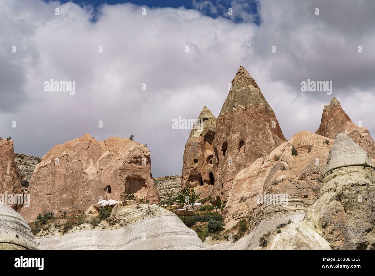 Jagged rock spires and eroded formations rise dramatically under a ...