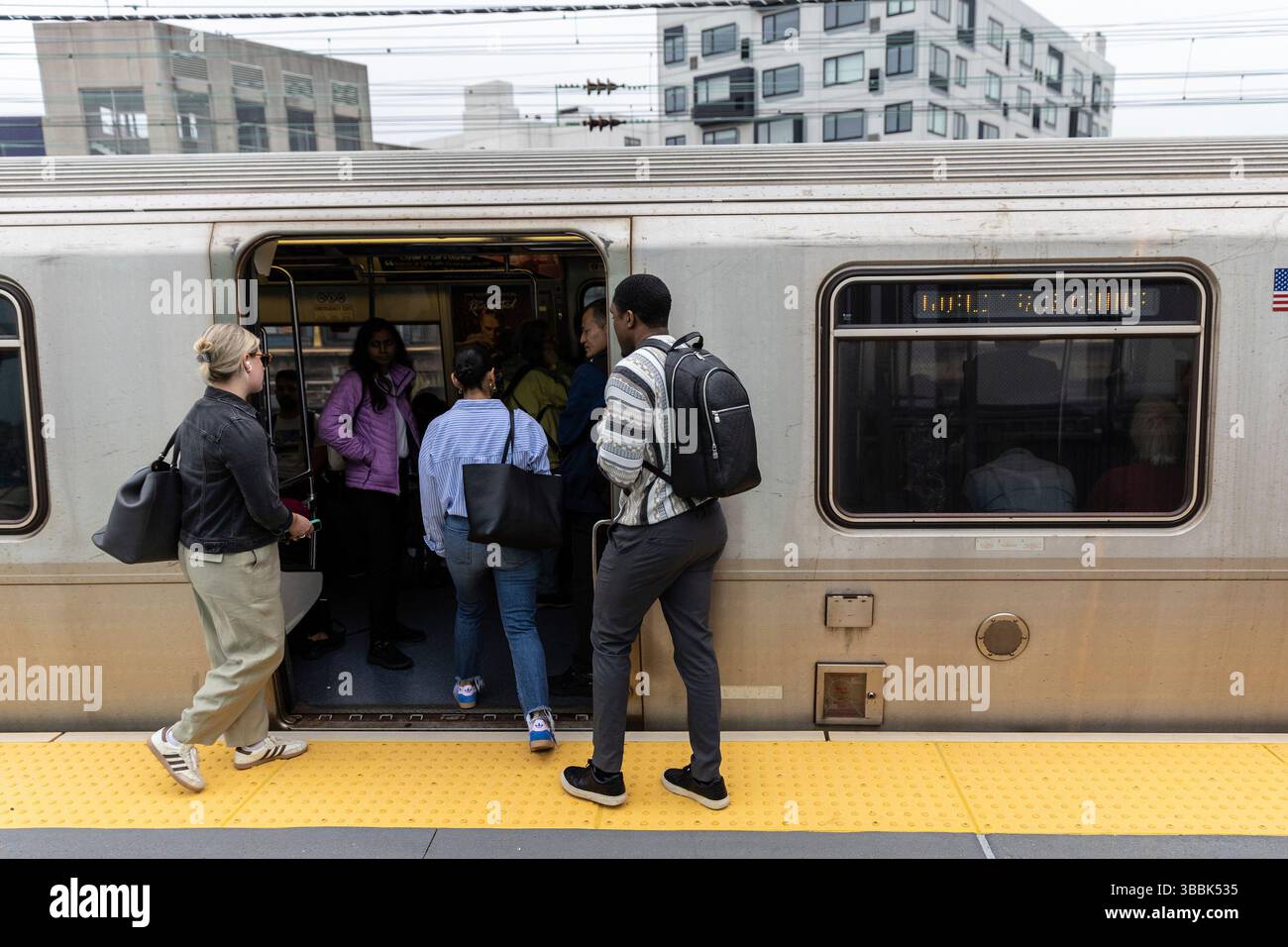 Commuters board a New York City bound PATH train at the Harrison PATH ...
