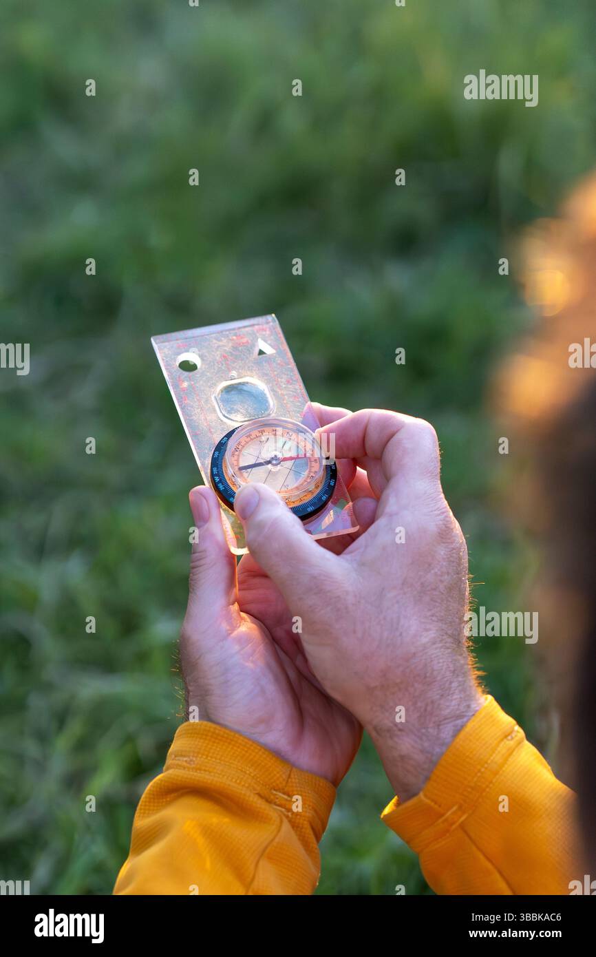 Explorer with compass in scenic landscape Stock Photo - Alamy