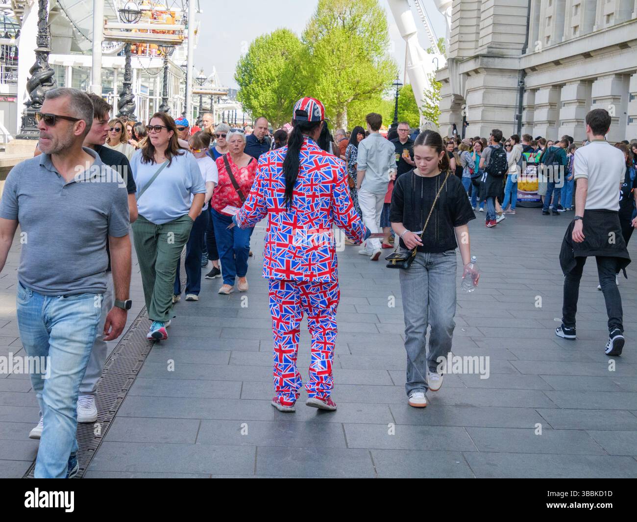 Man wearing union flag union Jack styled suit shoes and hat, hands out ...