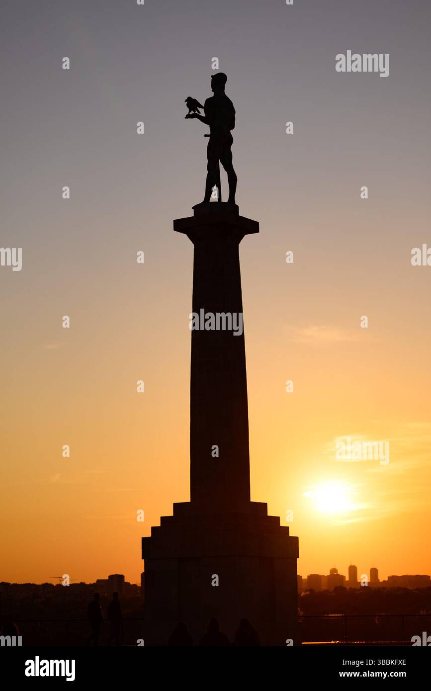 Silhouette of Victor monument, symbol of Belgrade, with sunset sky in ...