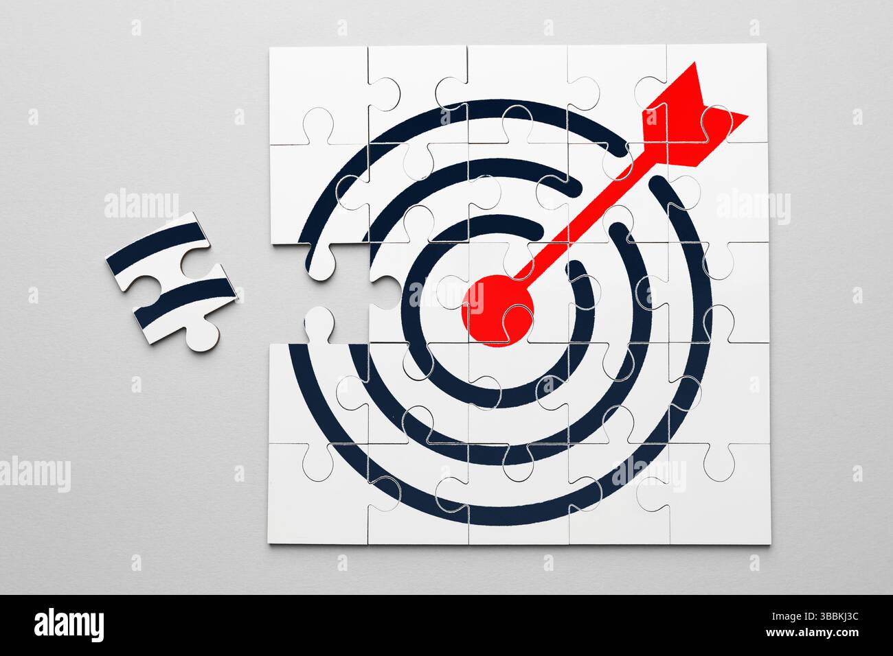 Targeting. One puzzle piece missing to make image of bullseye on light ...