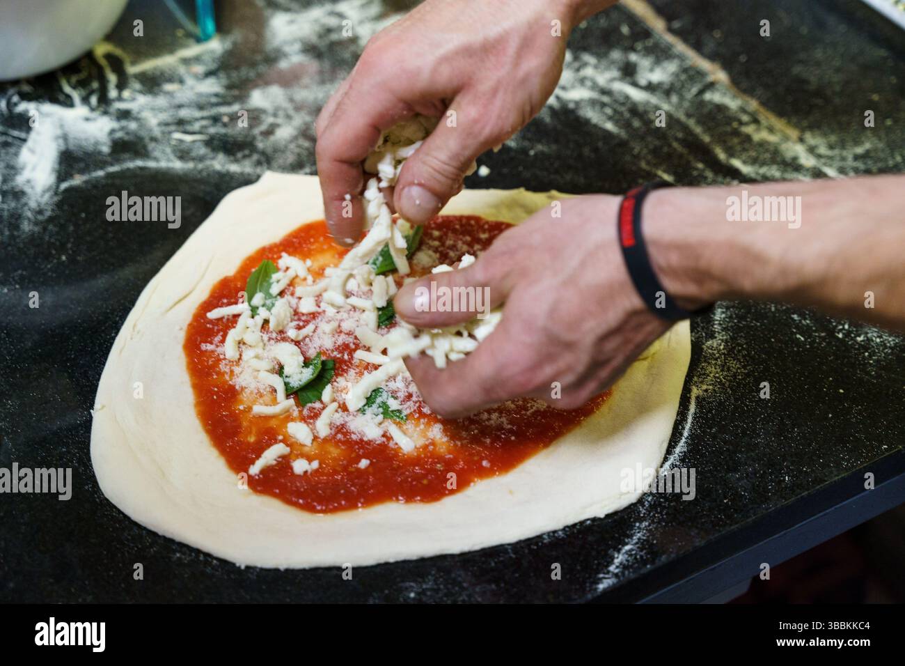 Chef sprinkles pizza mozzarella cheese hi-res stock photography and ...