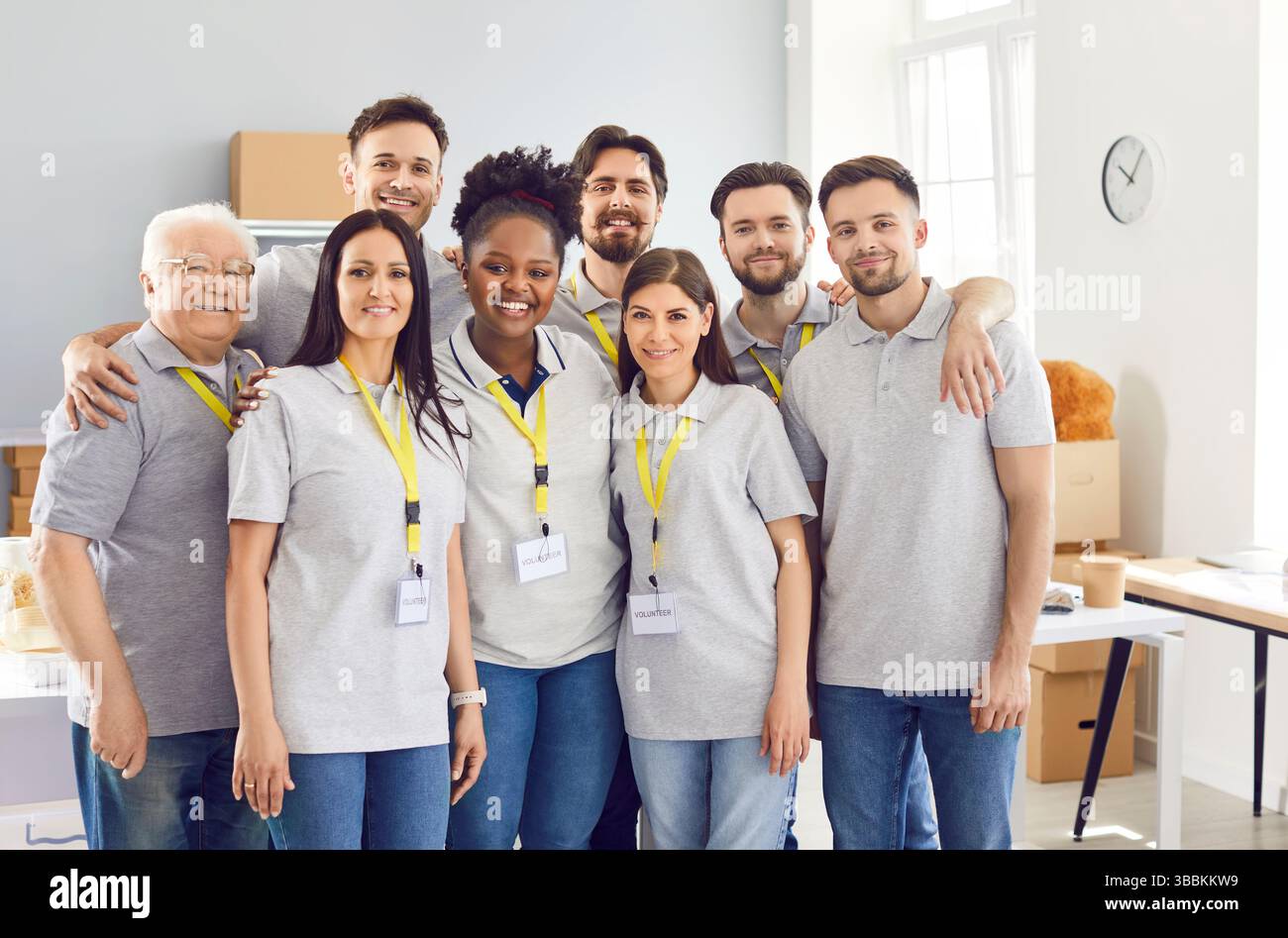 Group portrait of diverse volunteers that do charity work at a food aid ...