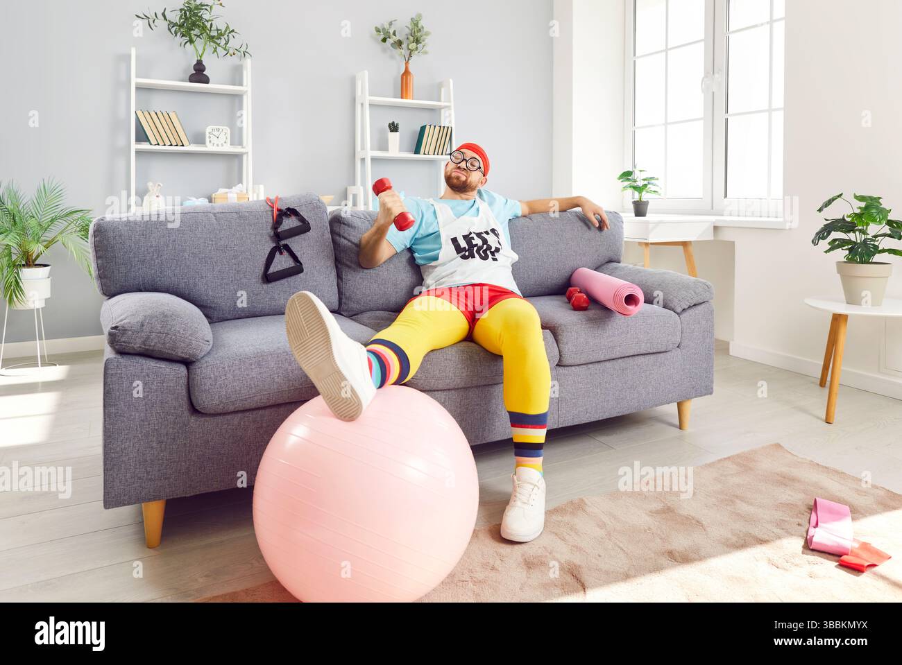 Funny happy sportsman relaxing pose doing body rest on sofa, exercise ...