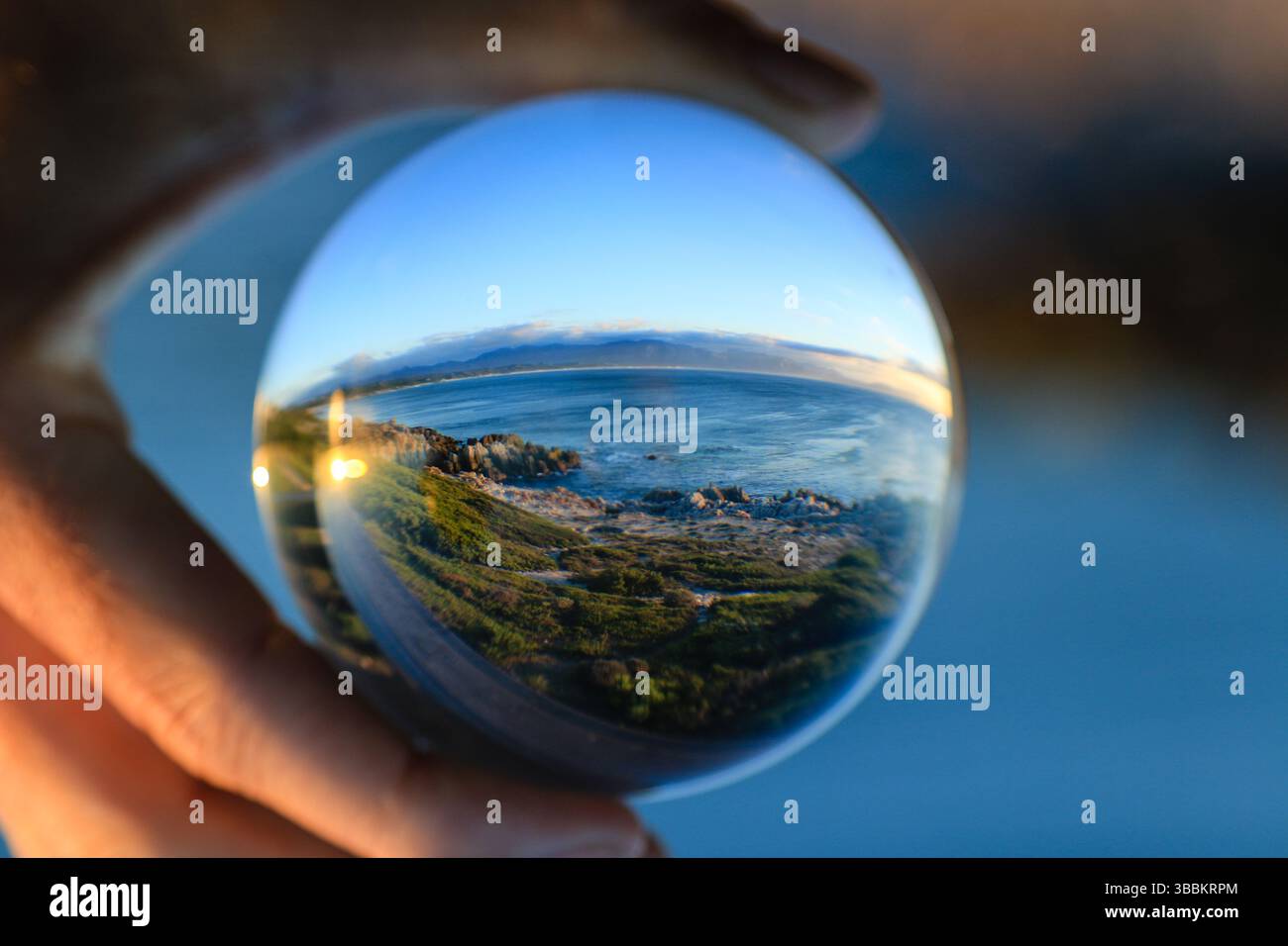 Hand holding a lens ball with landscape Stock Photo - Alamy