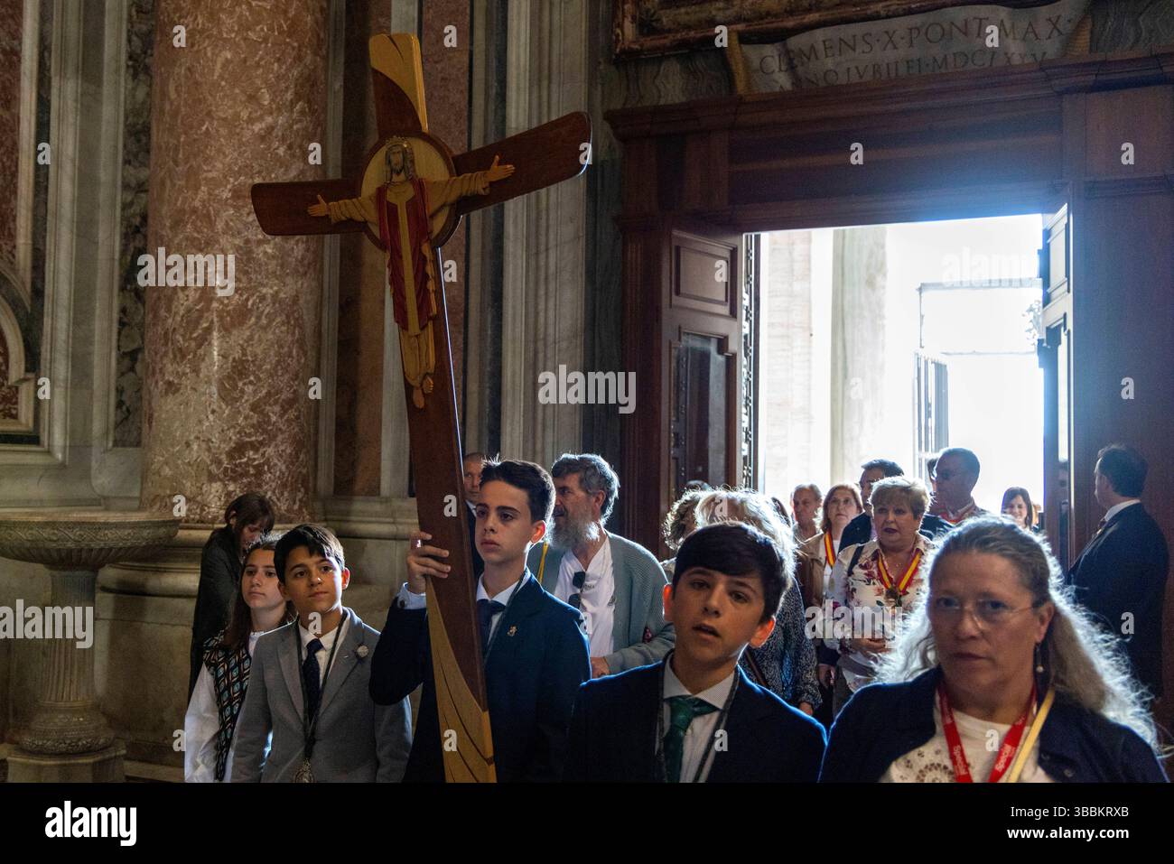Jubilee Saint Peters Basilica - Holy door Pilgrims hold a cross as they ...