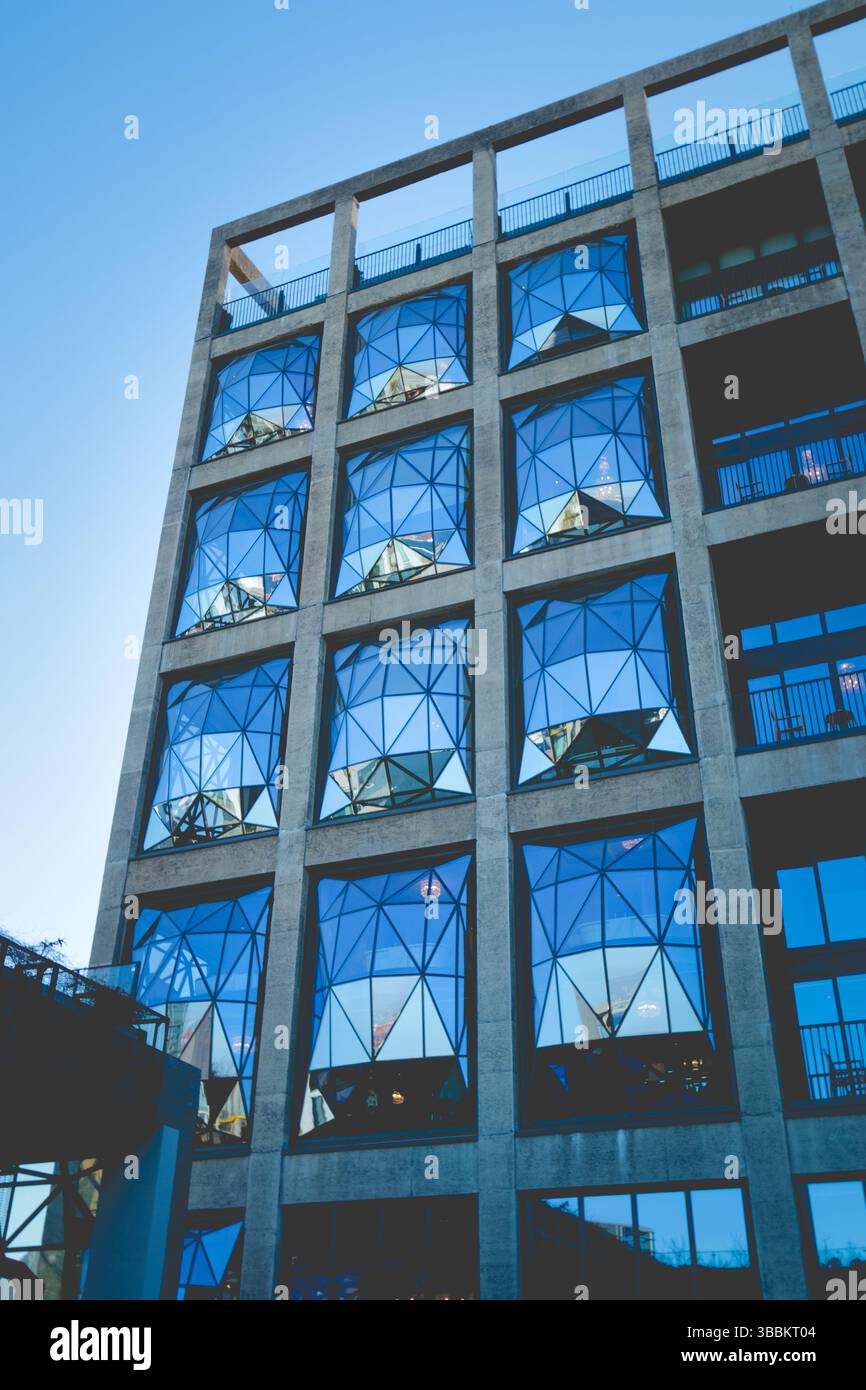 Building with glass geometric shaped windows Stock Photo - Alamy