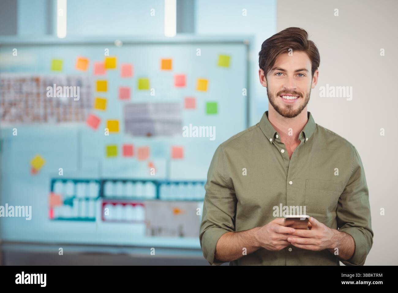Whiteboard displaying colorful sticky notes, diagrams in office space ...