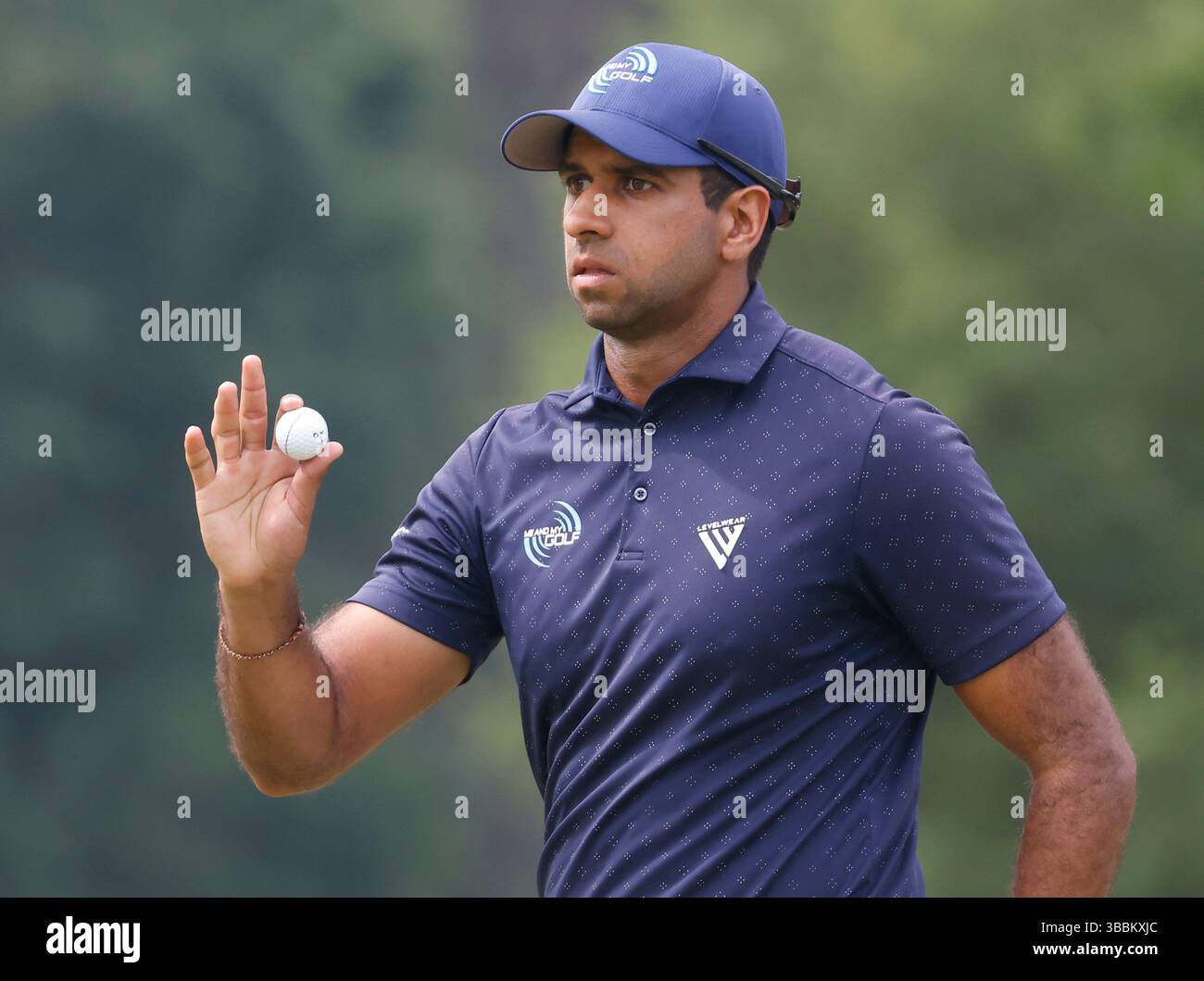 Aaron Rai of England reacts after sinking a putt on the 9th hole during ...