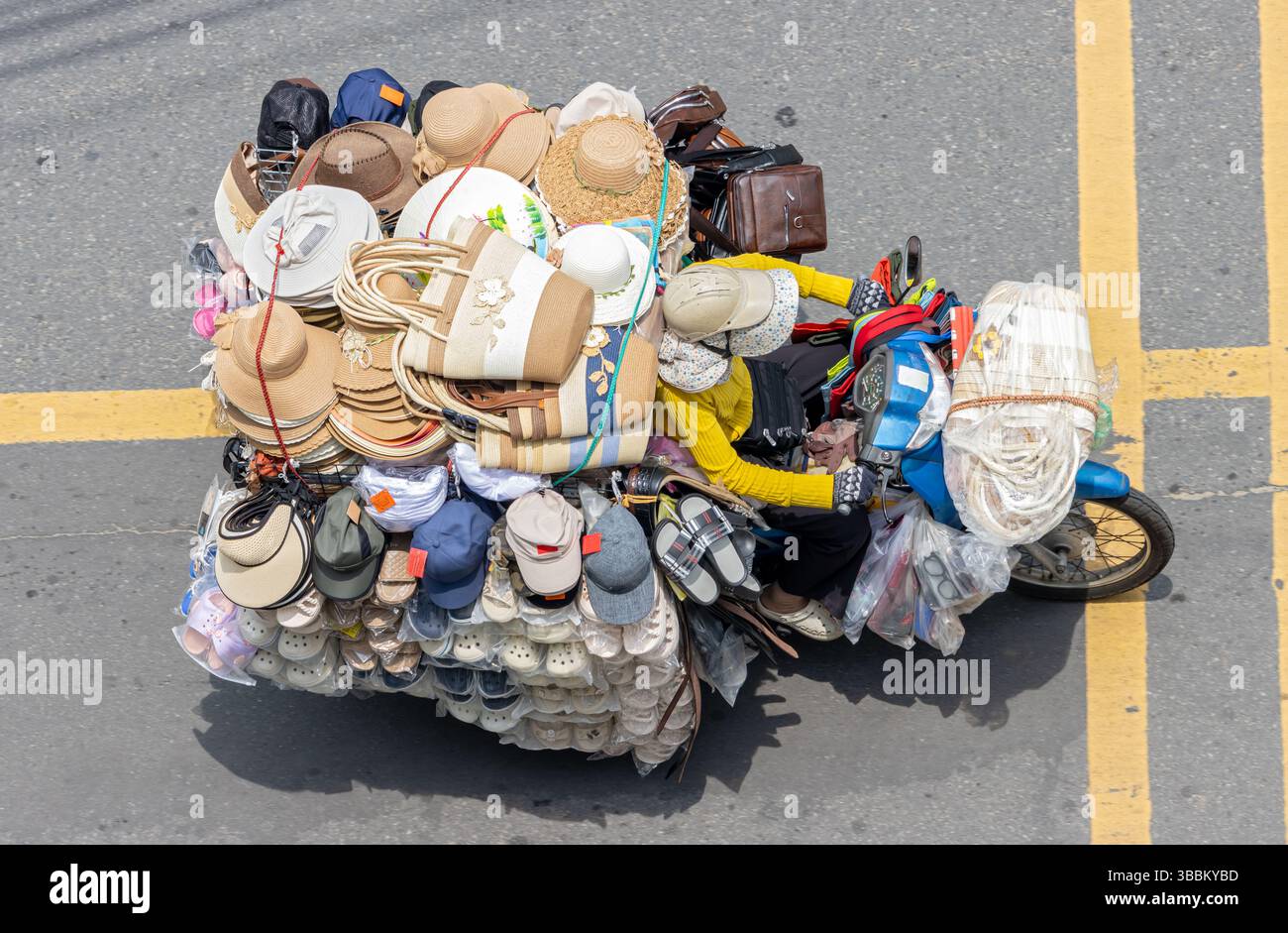 A motorcycle of vendor loaded with a variety of hats and merchandise ...