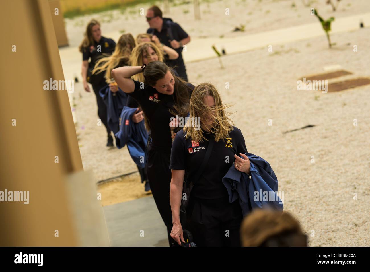 A sand storm makes the hair of curling athlete Sofia Mabergs of, Sweden. , . fly during Olympic ...