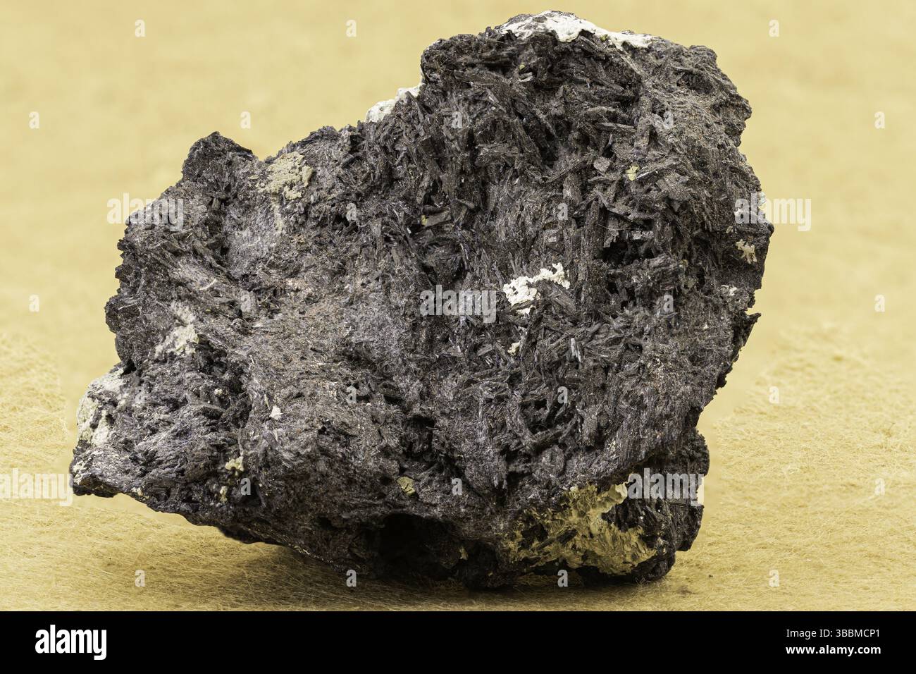 Dark mineral rock with fibrous texture and metallic reflections. Ideal ...