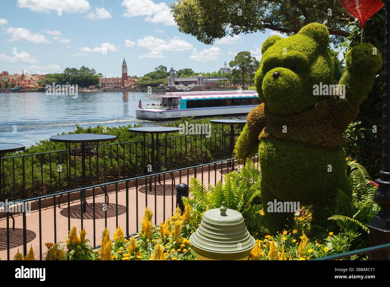 A Winnie the Pooh topiary and a Boat on World Showcase lake, the Italy ...