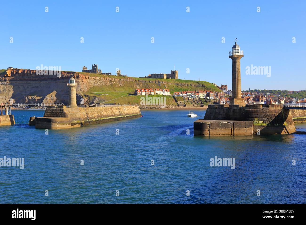 Lighthouses on Whitby harbour entrance with St Mary's Church and Whitby ...