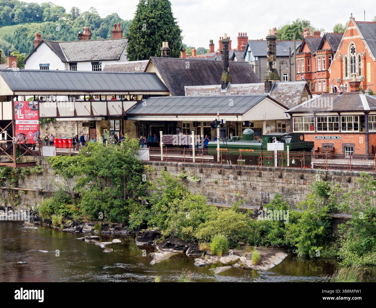 Llangollen Rai9lway station seen across the River Dee with a steam loc ...