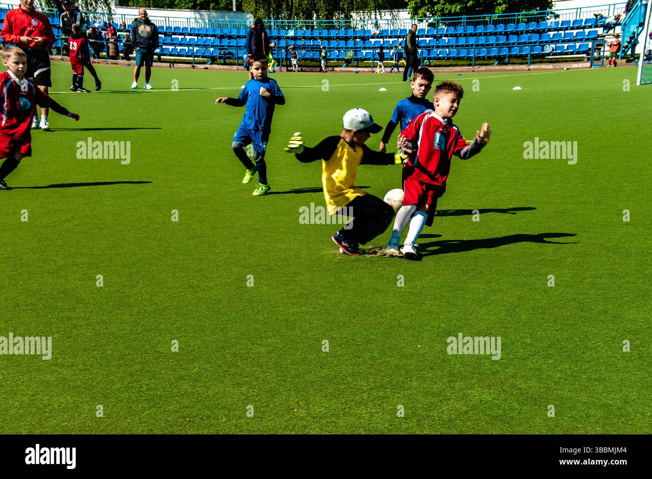 Unidentifiable kids playing football Stock Photo - Alamy