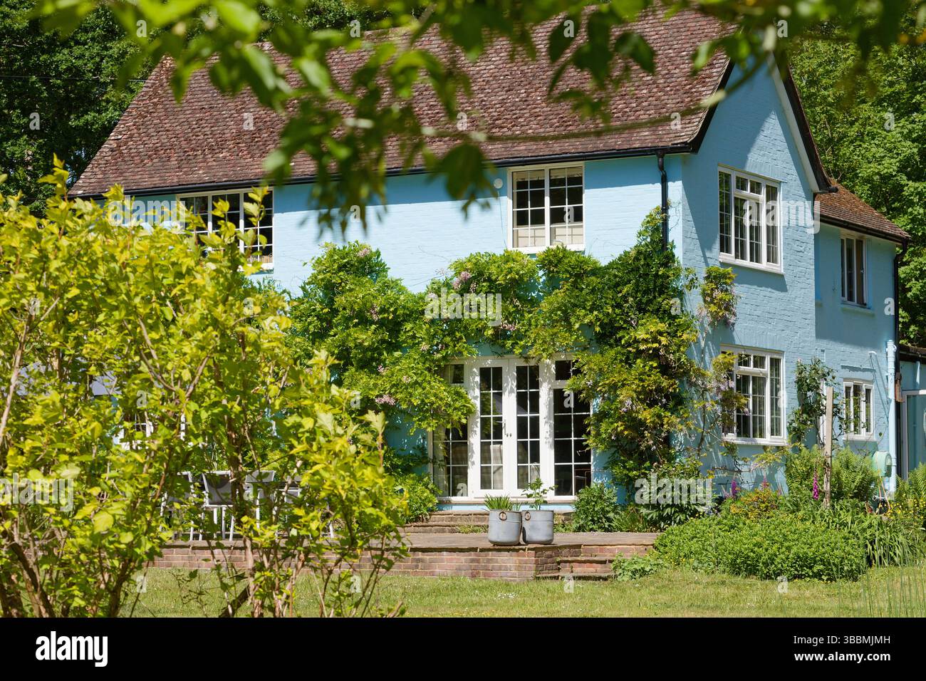 A blue painted house. A traditional brick built home with modern ...
