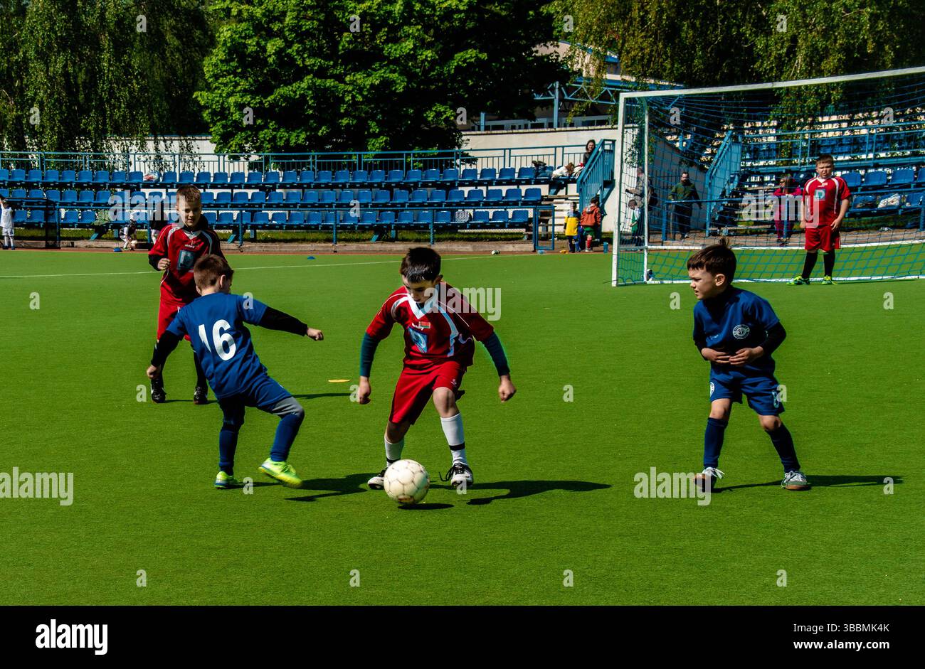 Kids in field playing soccer game Stock Photo - Alamy