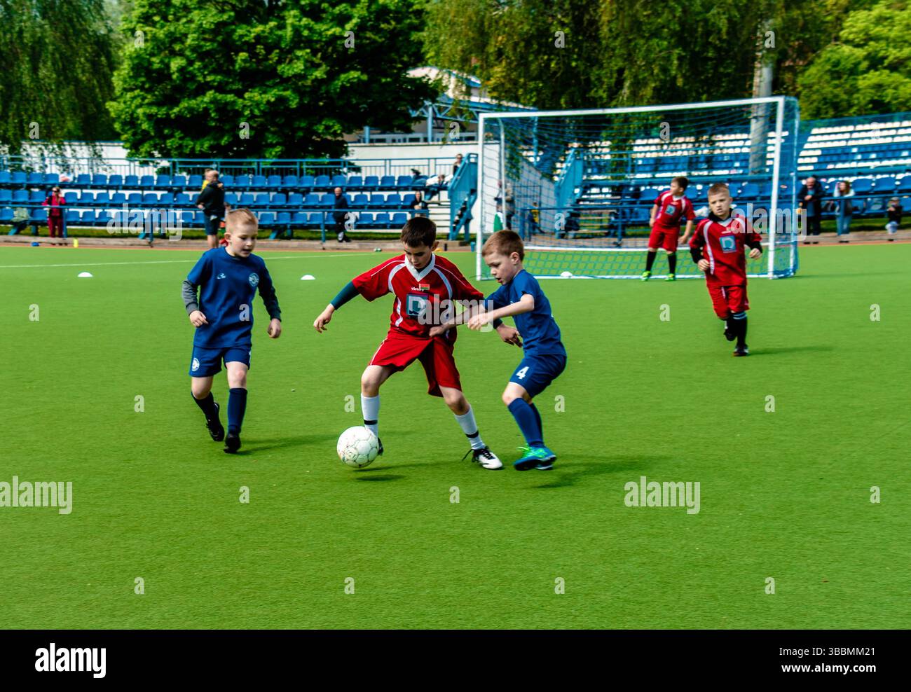 Kids play football on green lawn. Children running soccer ball game ...
