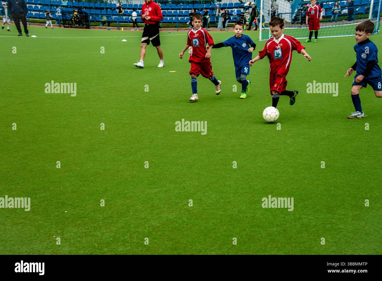 Kids in field playing soccer game Stock Photo - Alamy