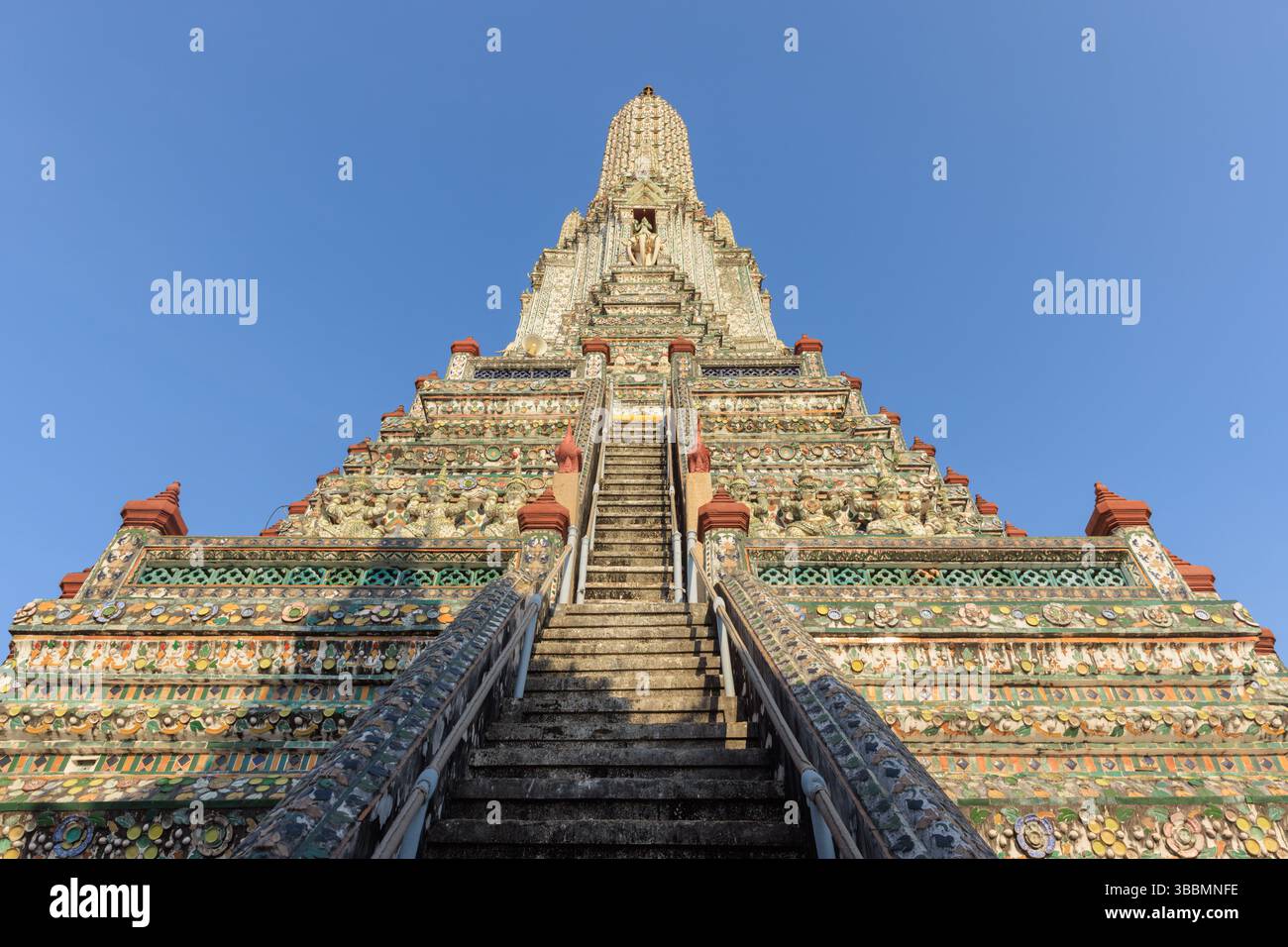 Visitors admire Wat Arun with its intricate design and towering ...