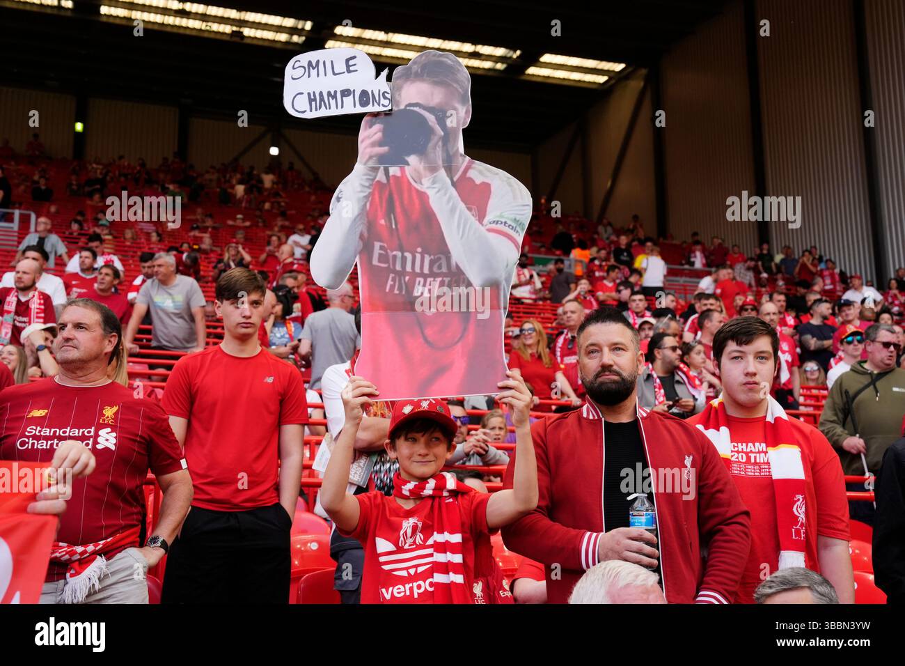 Liverpool fans holding a sign referencing Arsenal's Martin Odegaard ...