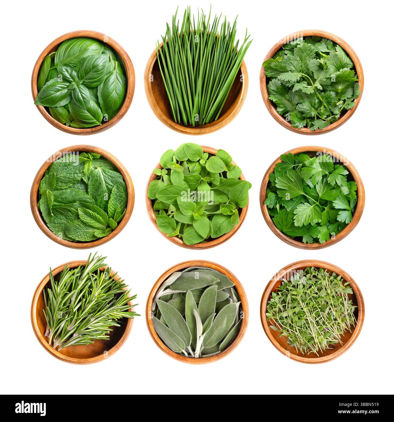 Most commonly used fresh herbs in wooden bowls. Basil, chives, and ...