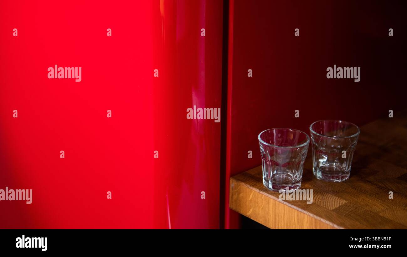 Two Vodka Shots on Wooden Counter with Red Background Stock Photo - Alamy