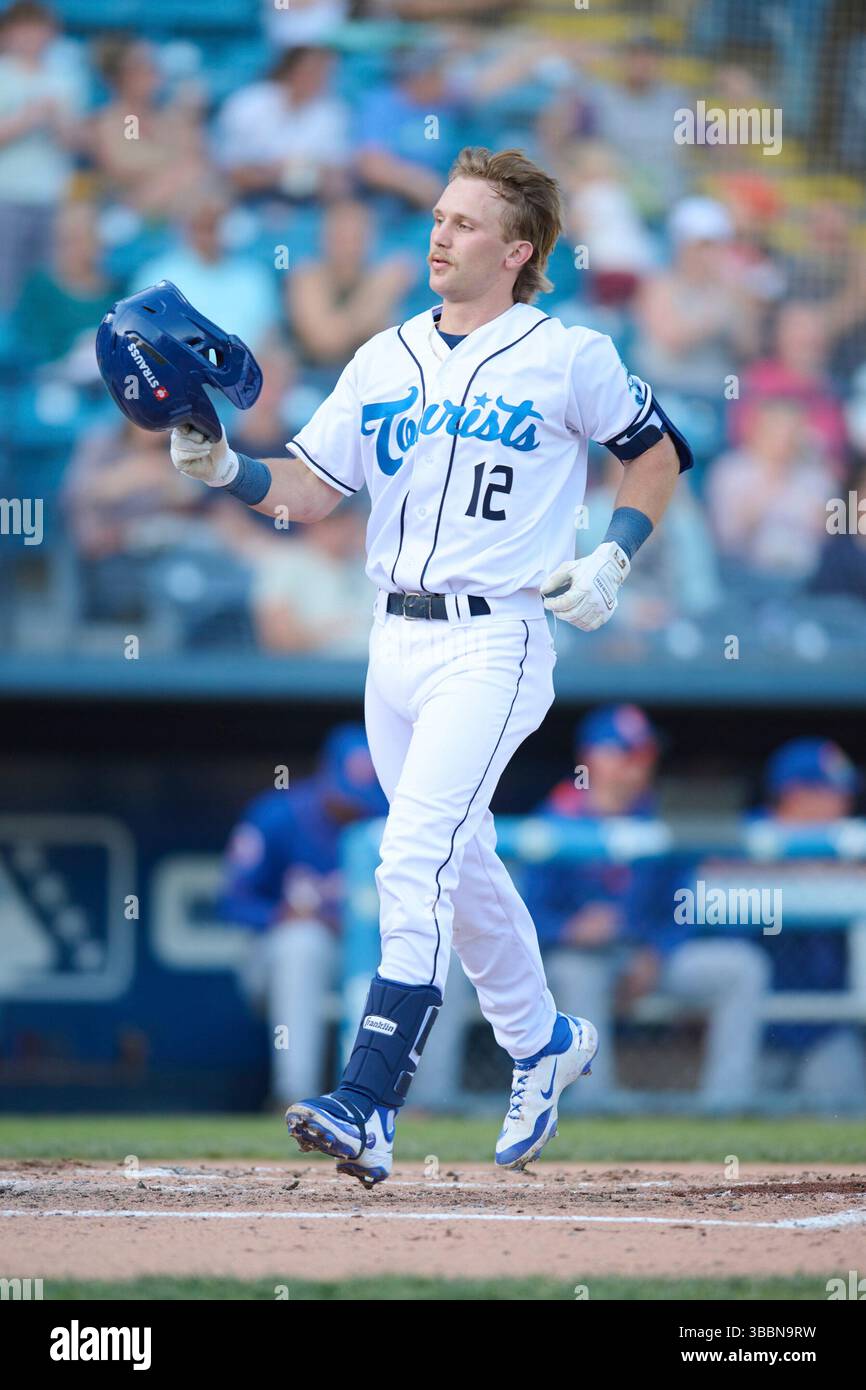 Asheville Tourists Walker Janek (12) crosses home plate after hitting a ...