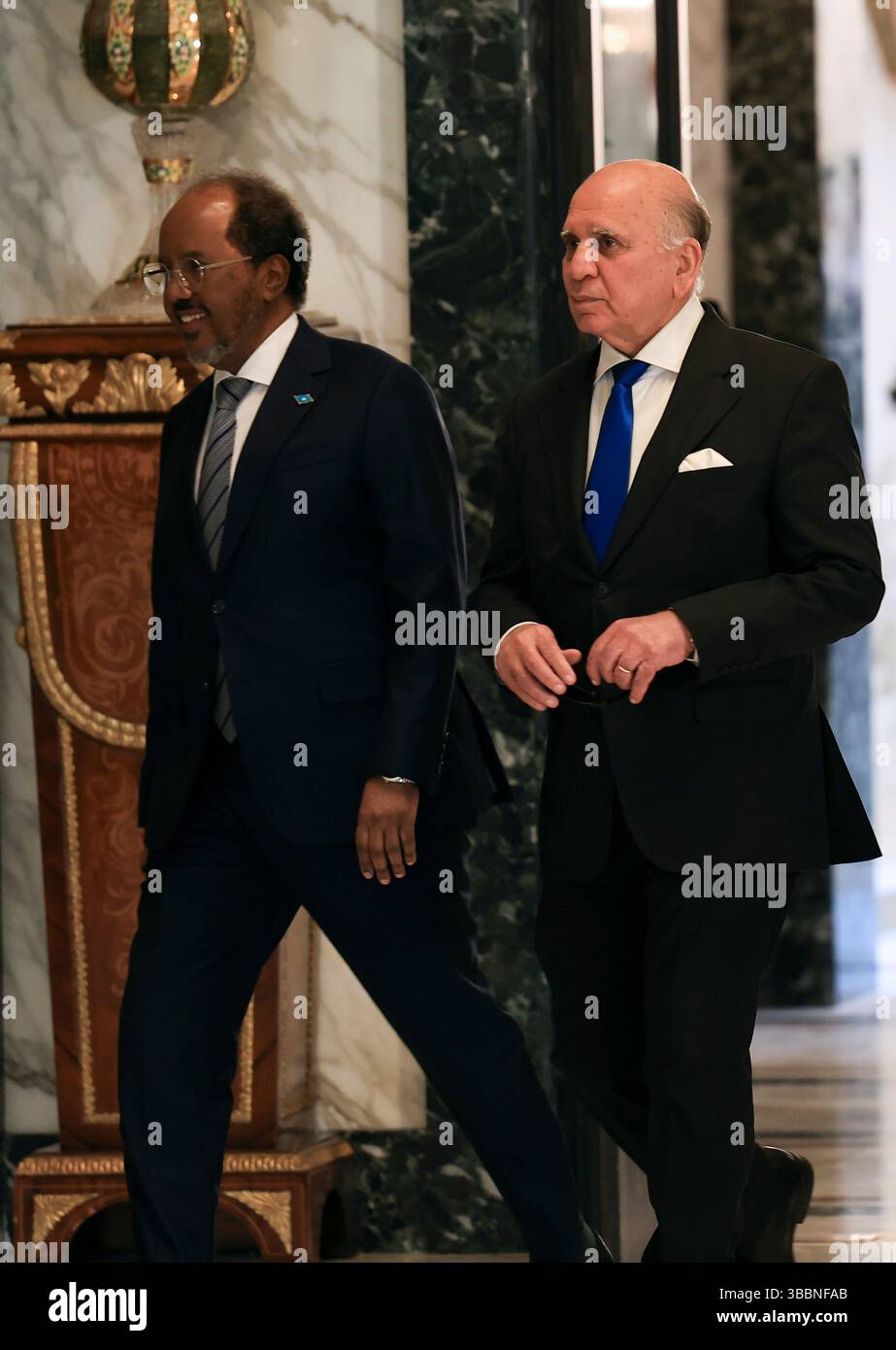 Iraqi Foreign Minister Fuad Hussein walks with Somali President Hassan ...