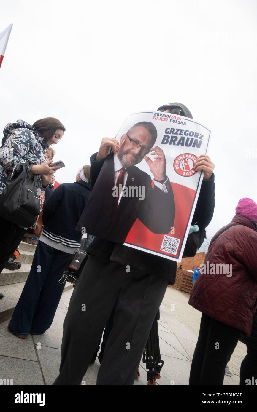 Warsaw, Poland, 16.05.2025. spectator with election poster seen at ...