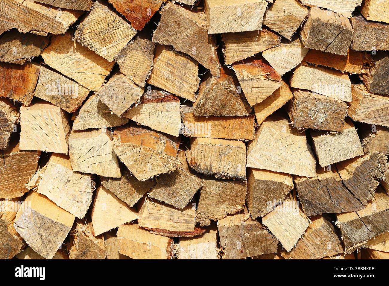 Stack of chopped firewood. Natural wooden logs for winter. Cut timber ...