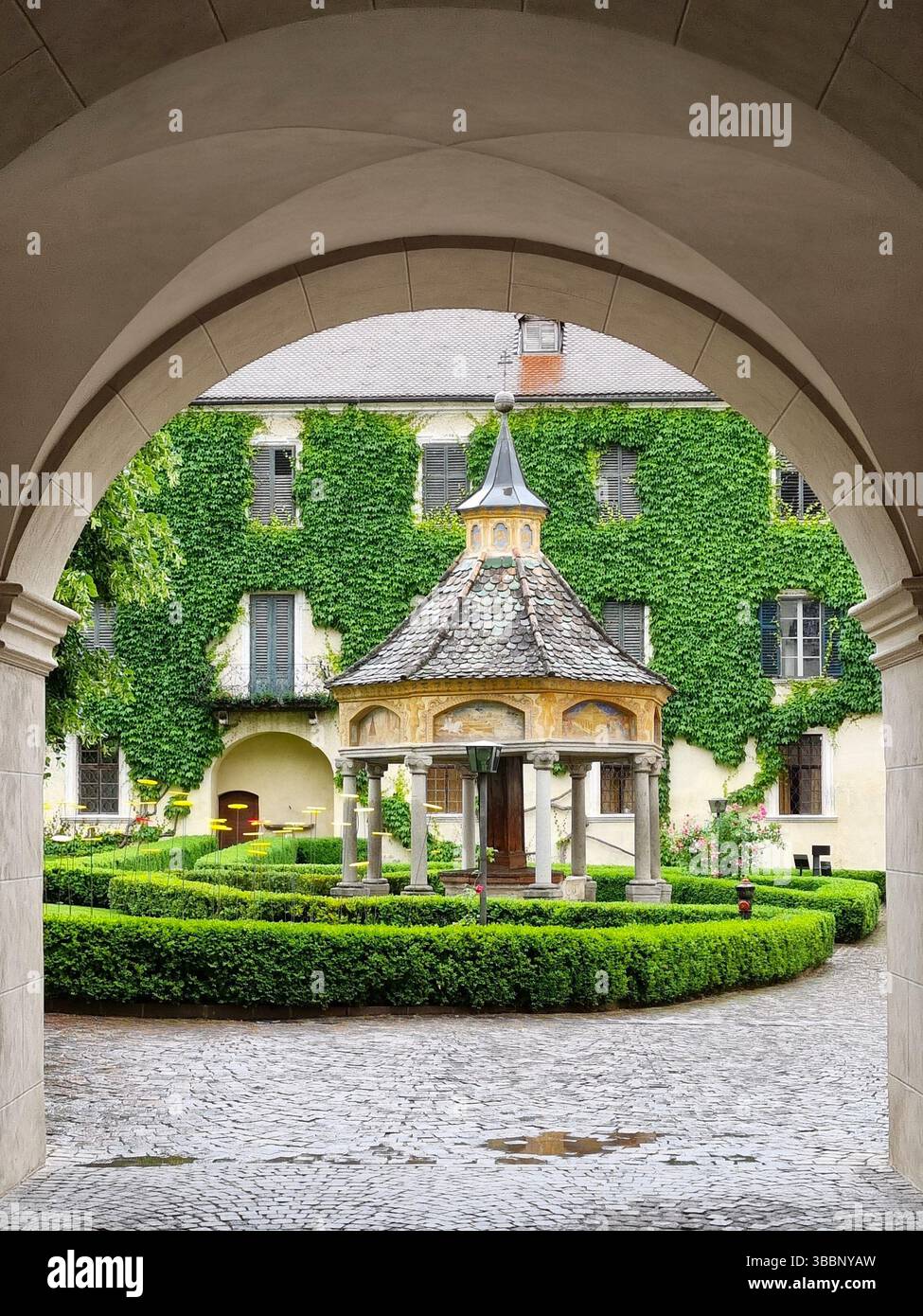 View of an ancient covered Well of Miracles, through an archway in the ...