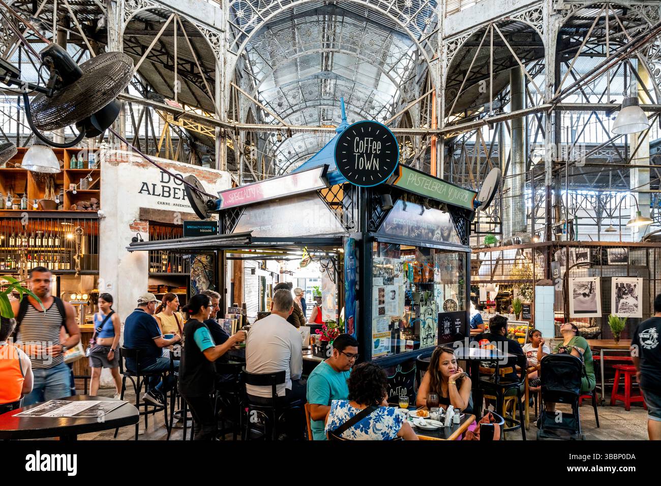 Tourists and Locals Sitting Down Eating At A Cafe Inside The Mercado De ...