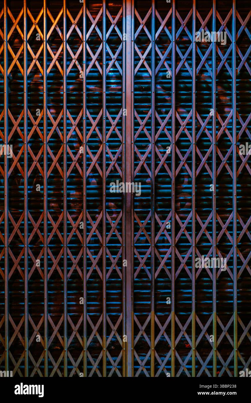Metallic gate with geometric pattern at night Stock Photo - Alamy