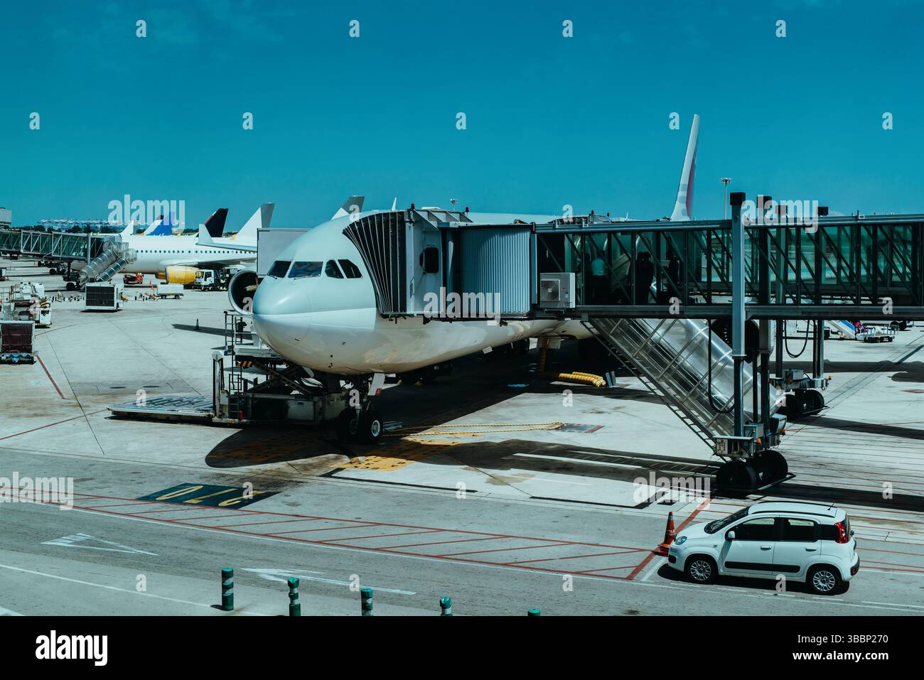 Airplane at the airport takes passengers through telescopic ladder ...