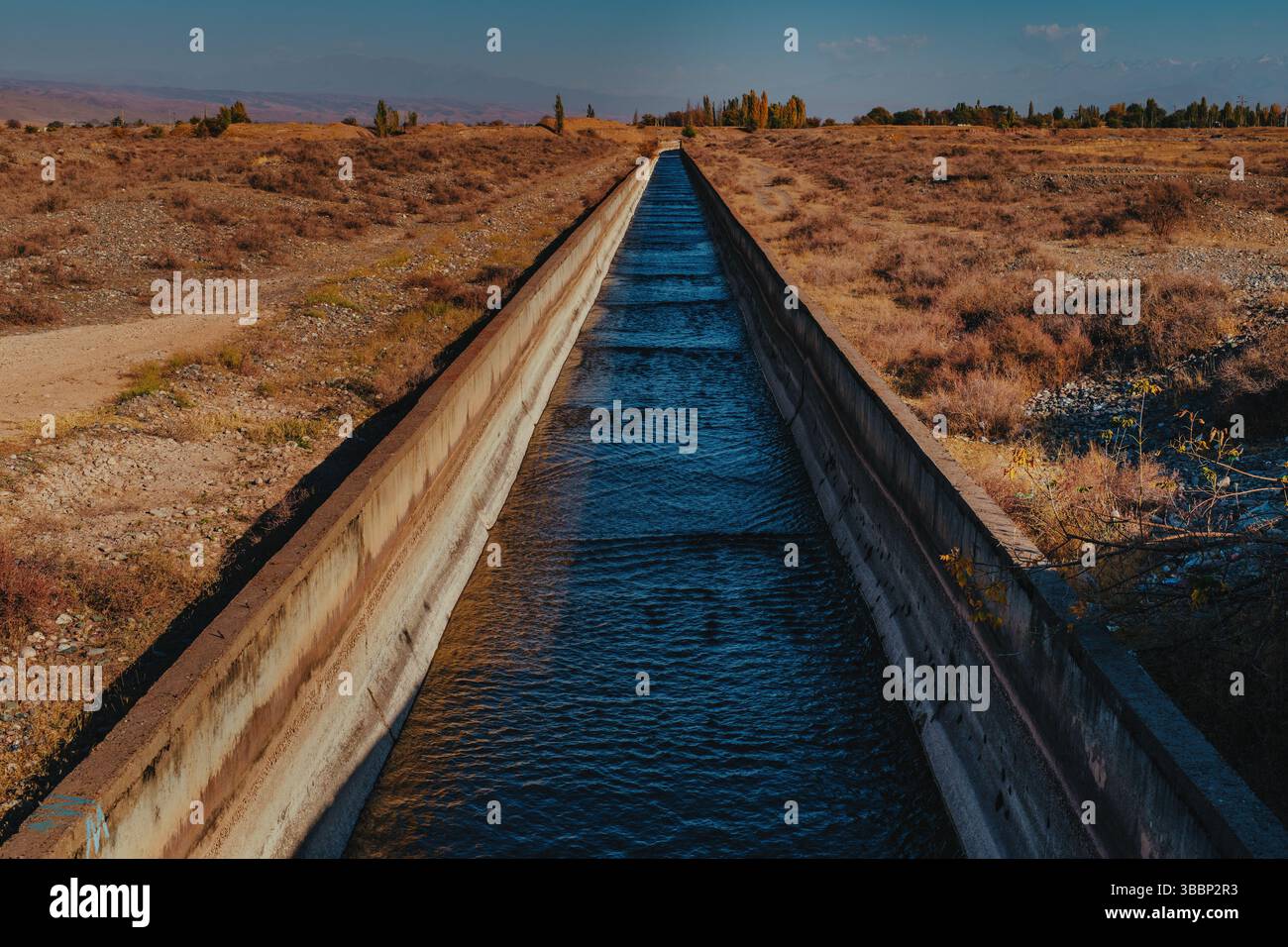 Water supply canal in arid desert area Stock Photo - Alamy