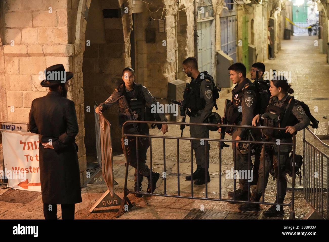 Israeli security forces stand guard near the scene of a stabbing attack ...