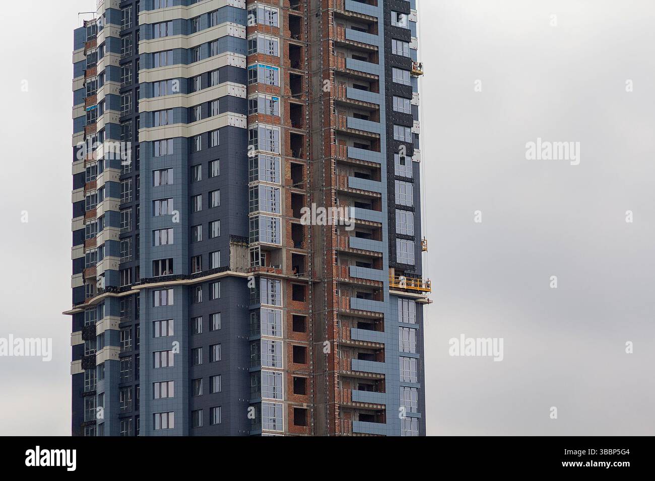 Works on the facade of a modern multi-storey building. Construction ...